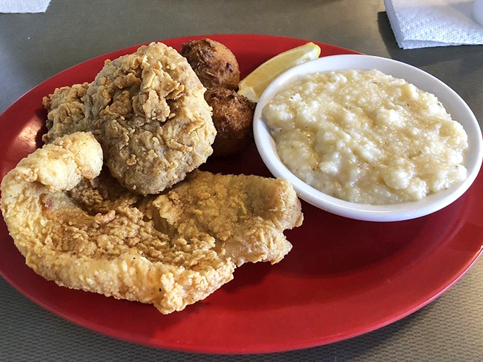 Seafood this fresh doesn't need a fancy plate. The golden-fried fish and hush puppies on a red plate is the Gulf Coast's version of fine dining.