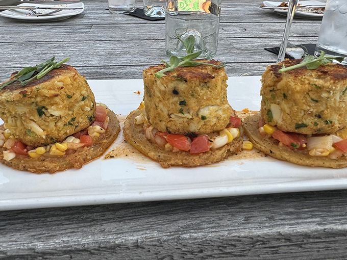 These crab cakes perch like savory sculptures on crisp platforms, a delicious testament to the kitchen's commitment to presentation and flavor.