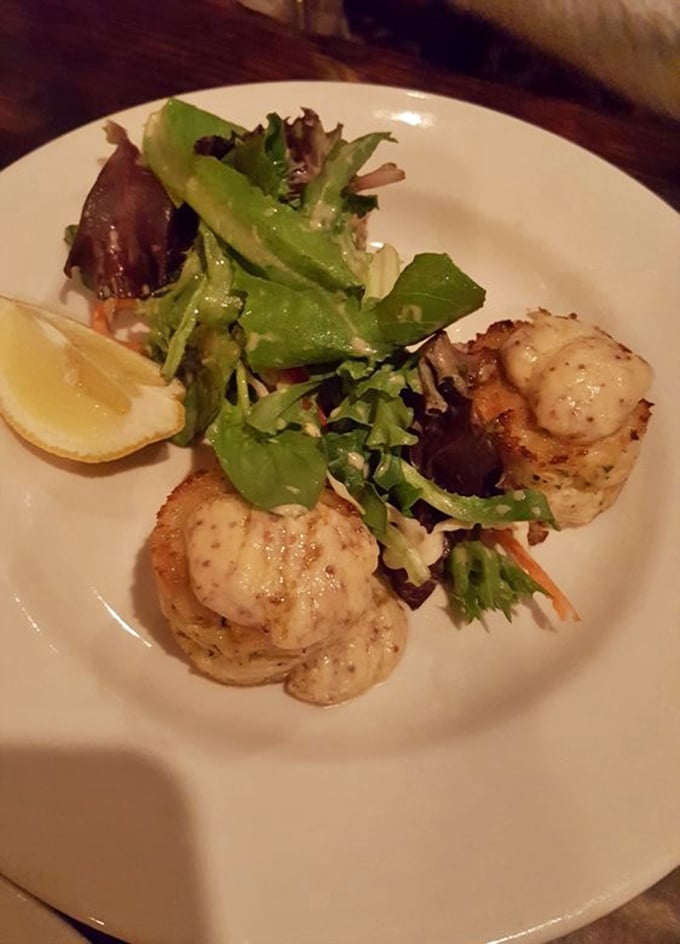 These crab cakes arrived dressed to impress, golden and gorgeous atop fresh greens like edible jewelry.