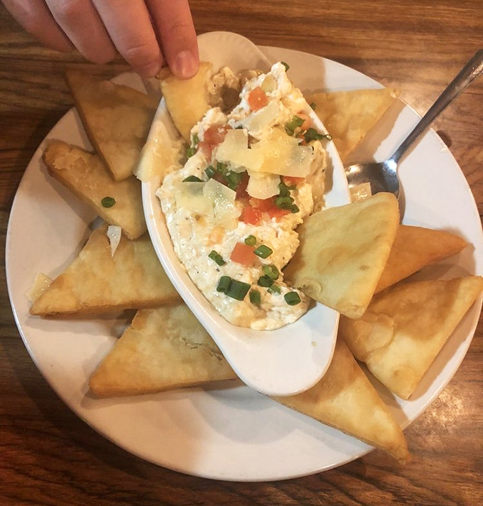 Dive right in! Golden pita triangles surround a creamy crab dip studded with colorful veggies&mdash;the perfect shareable start to your seafood adventure.
