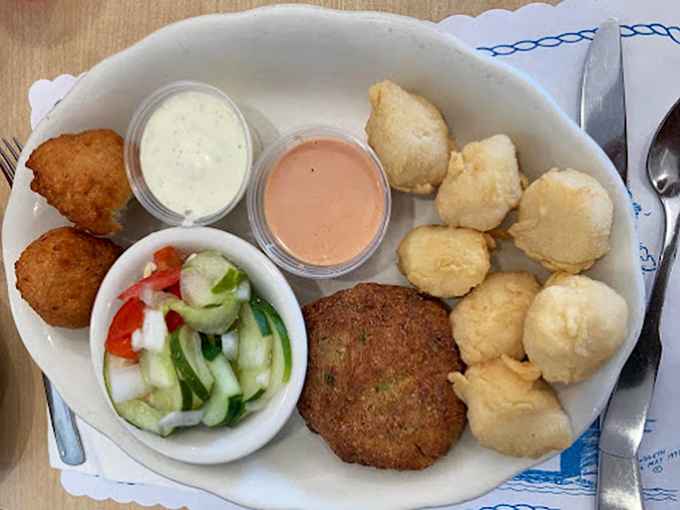A seafood platter that makes you forget your table manners&mdash;hush puppies, crab cake, and cucumber salad creating the holy trinity of Southern sides.