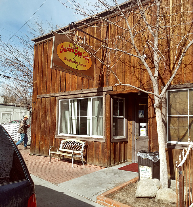The Cracked Egg Cafe's rustic wooden exterior promises the kind of hearty breakfast that fuels mountain adventures, not Instagram photoshoots.