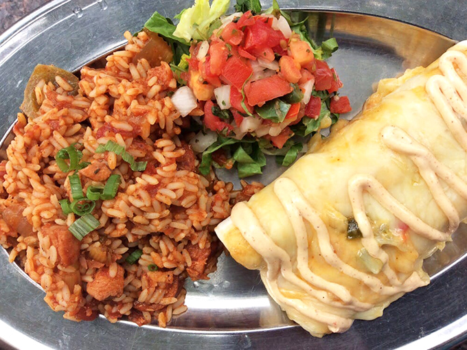 Cajun rice that's redder than a politician's face during a debate, paired with an enchilada that would make New Orleans proud.