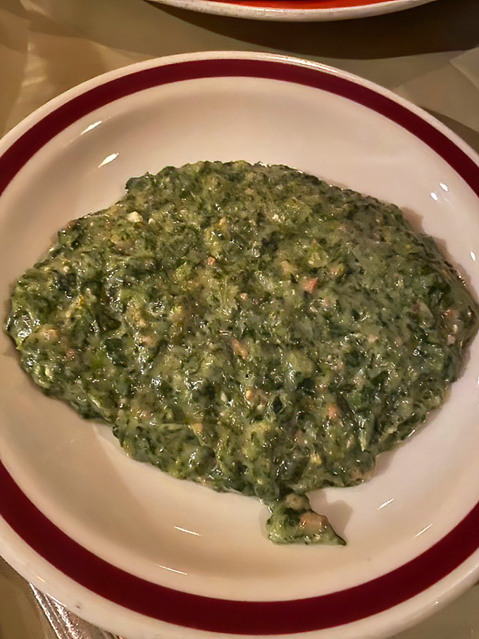 The creamed spinach arrives unapologetically rich and velvety – proof that vegetables can be decadent when they put their minds to it.