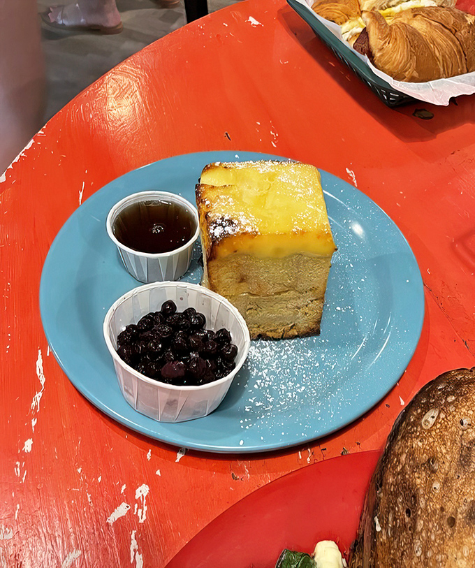 The Cr&egrave;me Br&ucirc;l&eacute;e French Toast arrives like breakfast royalty, with blueberries standing by as loyal courtiers to the caramelized throne.