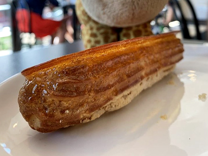 Golden, flaky, and impossibly buttery—this éclair isn't just pastry, it's edible architecture that crackles with promise at first bite.