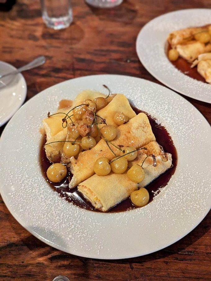 Delicate crepes nestled in a sweet sauce with golden grapes. Like a dessert that went to finishing school in Italy and came back with stories to tell.