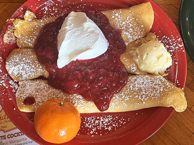 These crepes don't just serve fruit&mdash;they celebrate it. That mountain of strawberries and whipped cream is basically a breakfast carnival.