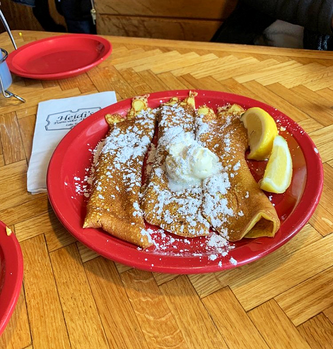 These crepes have dressed up for the occasion, wearing their finest powdered sugar snow and bringing a dollop of vacation joy.