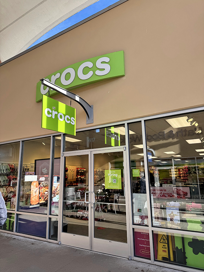 The lime-green Crocs storefront is like a beacon of comfortable rebellion&mdash;where practical footwear meets unexpected style at outlet prices. 