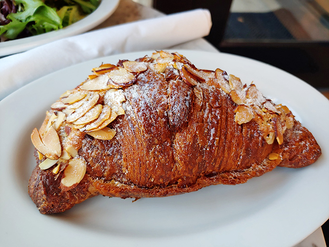 This almond croissant isn't just breakfast; it's edible architecture with layers that pull apart in a satisfying dance of butter and flour.