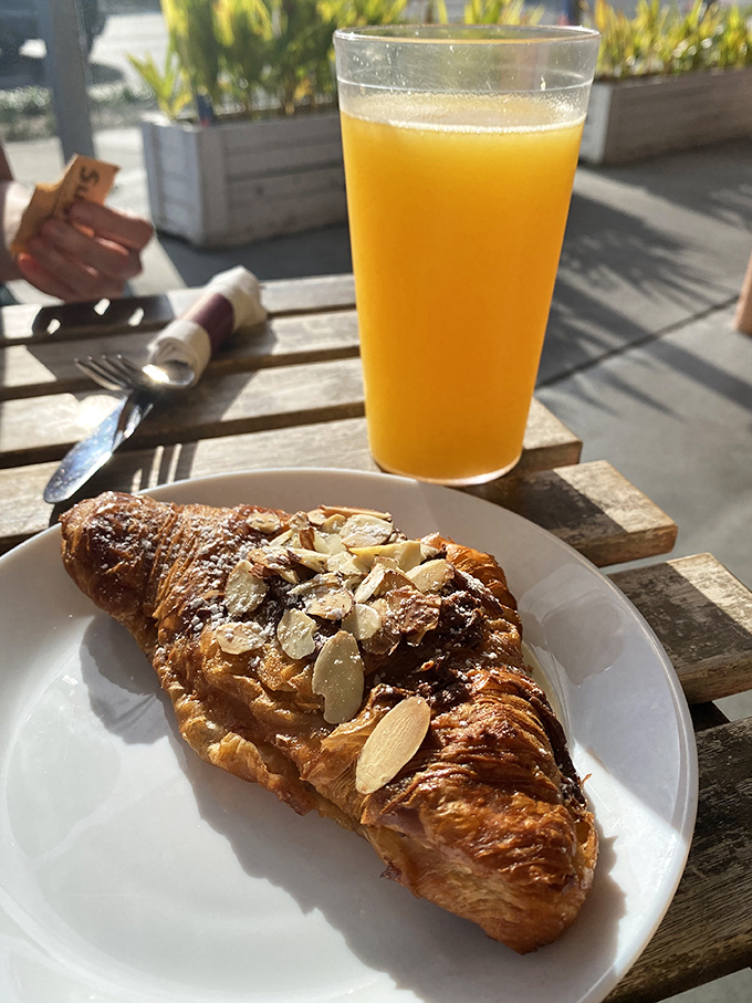 Golden-brown almond croissant paired with fresh orange juice&mdash;the breakfast combo that makes Monday feel like Saturday in Provence.