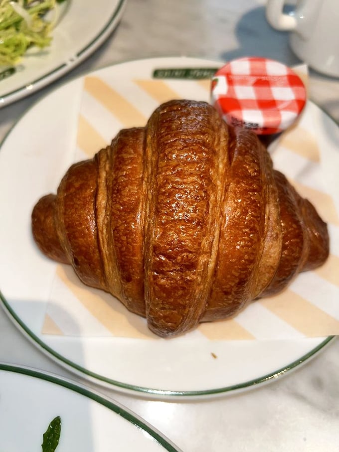 That croissant isn't just baked&mdash;it's been coaxed into golden, buttery perfection through what I can only assume is some form of French pastry whispering.