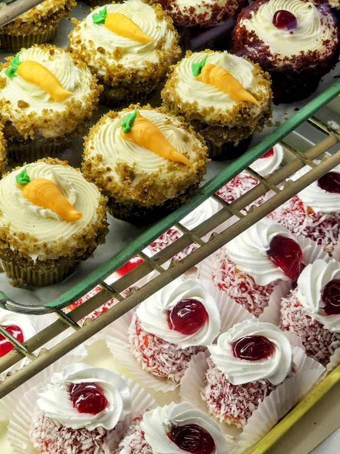 Carrot cake cupcakes topped with tiny orange carrots &ndash; the only vegetables you'll ever crave. Below, coconut-covered treats wait patiently for their moment of glory.