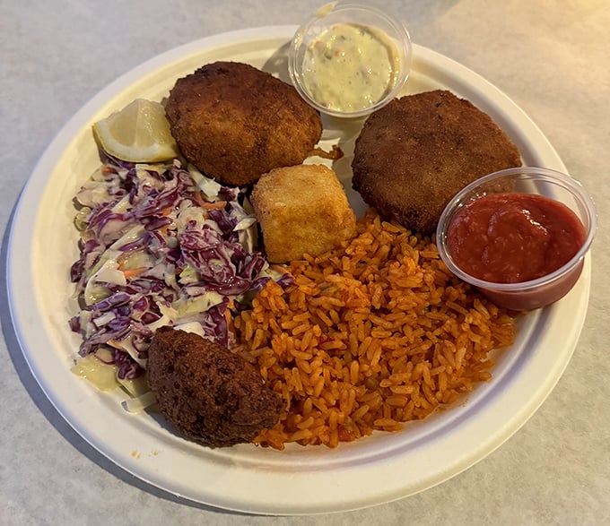 Deviled crab that would tempt a saint, served with the holy trinity of Southern sides: red rice, slaw, and a cornbread square that's worth fighting over.