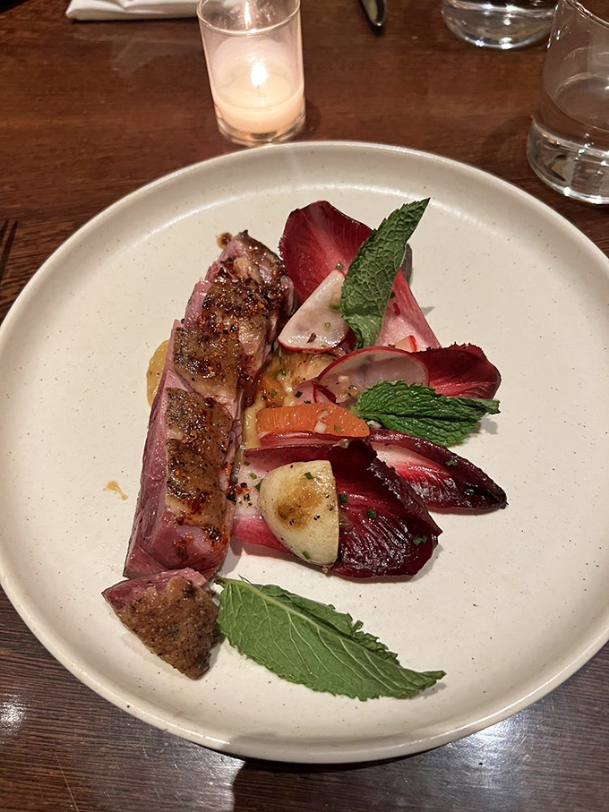 Duck breast that's dressed for success, accompanied by a colorful entourage of seasonal vegetables. The mint leaves add that "I'm sophisticated but still know how to party" vibe.