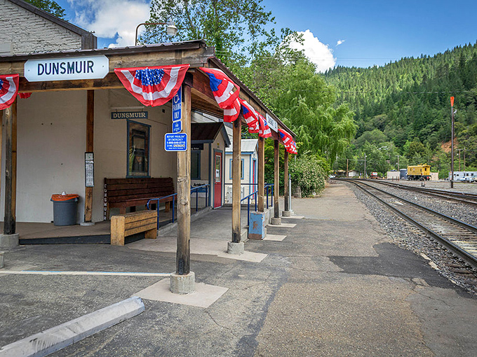 All aboard nostalgia! Dunsmuir's historic train station welcomes travelers just as it has for generations, American flags fluttering like friendly waves.