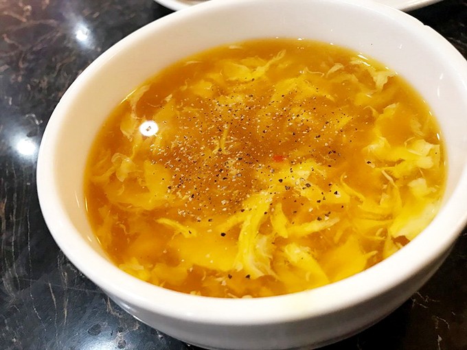 The egg drop soup &ndash; a golden pool of comfort that "prepares the stomach" according to buffet veterans. Wisdom in a bowl.