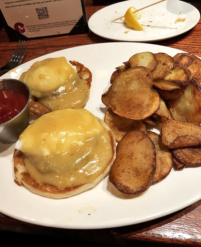 Eggs Benedict done right &ndash; perfectly poached eggs draped in hollandaise that's rich enough to need its own tax bracket. Those home fries deserve their own fan club.