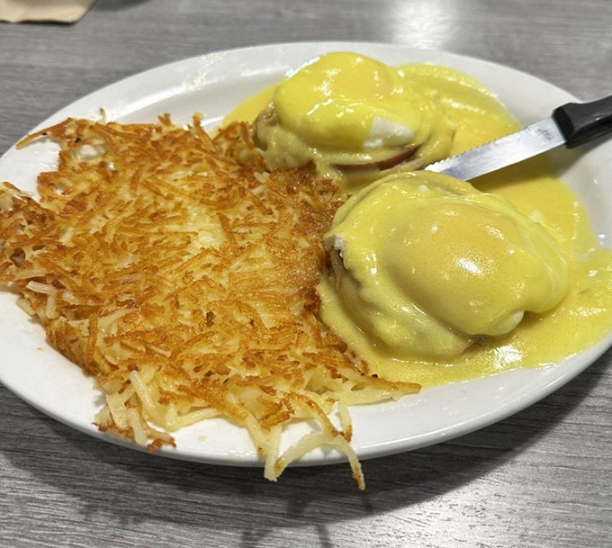 Eggs Benedict with a side of hash browns so crispy they deserve their own fan club. The hollandaise sauce? Liquid sunshine.