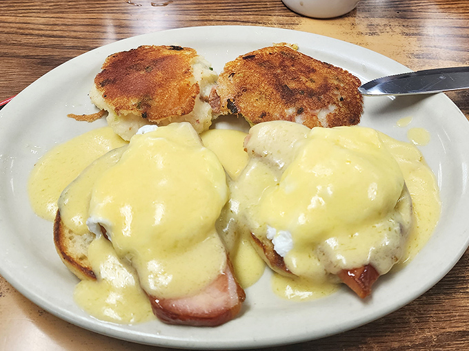 Eggs Benedict done right&mdash;where hollandaise sauce cascades like a yellow waterfall of buttery goodness over perfectly poached eggs.