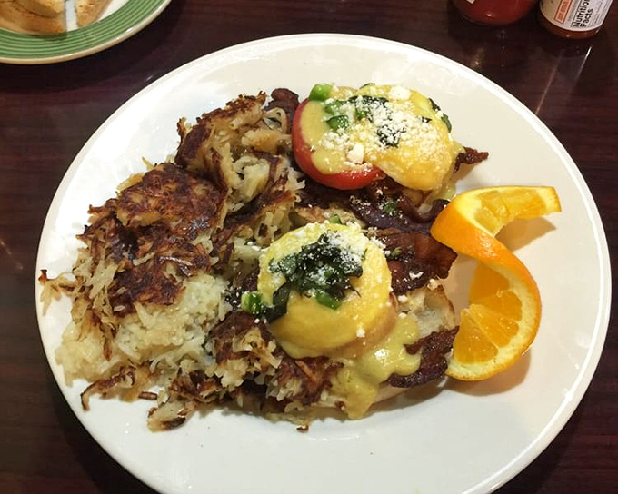 This Benedict isn't just eggs on an English muffin&mdash;it's a masterpiece of hollandaise architecture with perfectly crispy hash browns standing guard on the side.