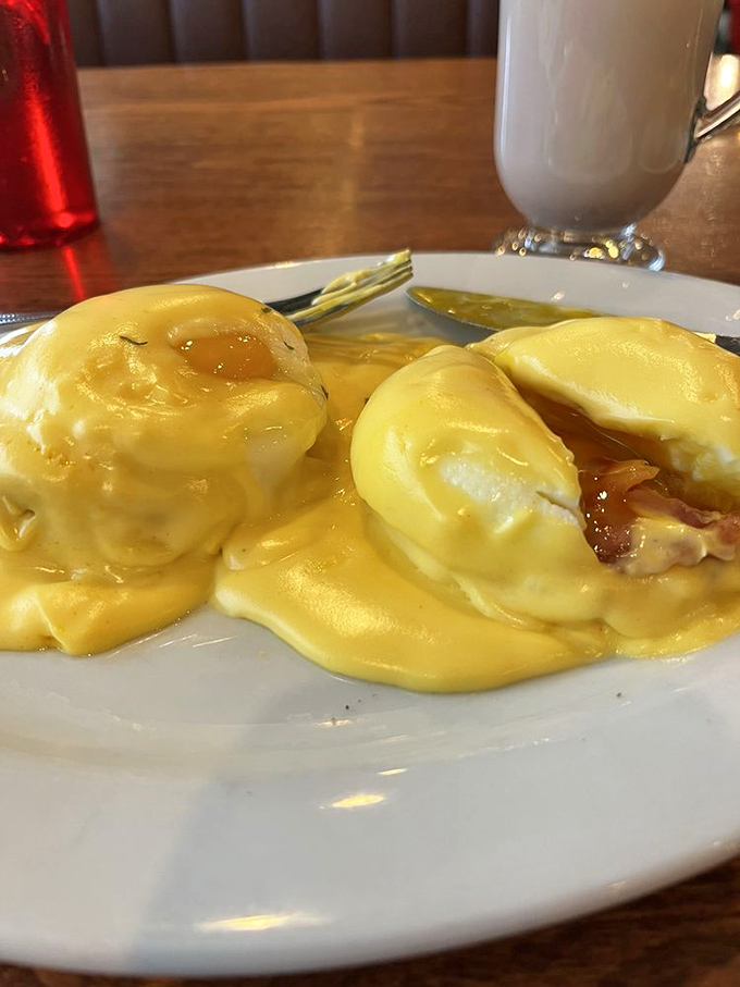 Eggs Benedict that would make a brunch enthusiast weep tears of hollandaise joy. Those perfectly poached eggs are living their best life under that golden sauce blanket.