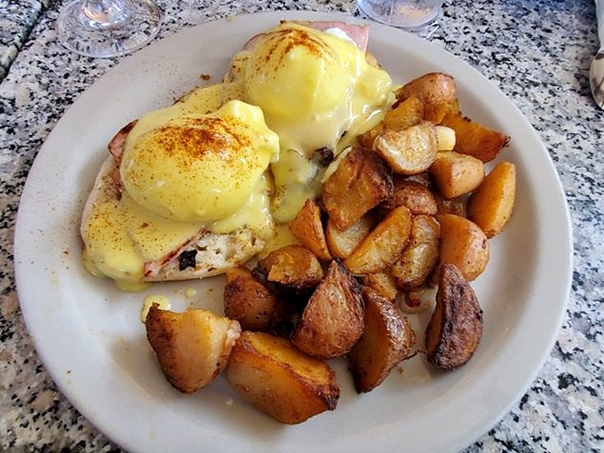 Eggs Benedict done right: perfectly poached eggs, hollandaise that should win awards, and potatoes crisped to golden perfection.