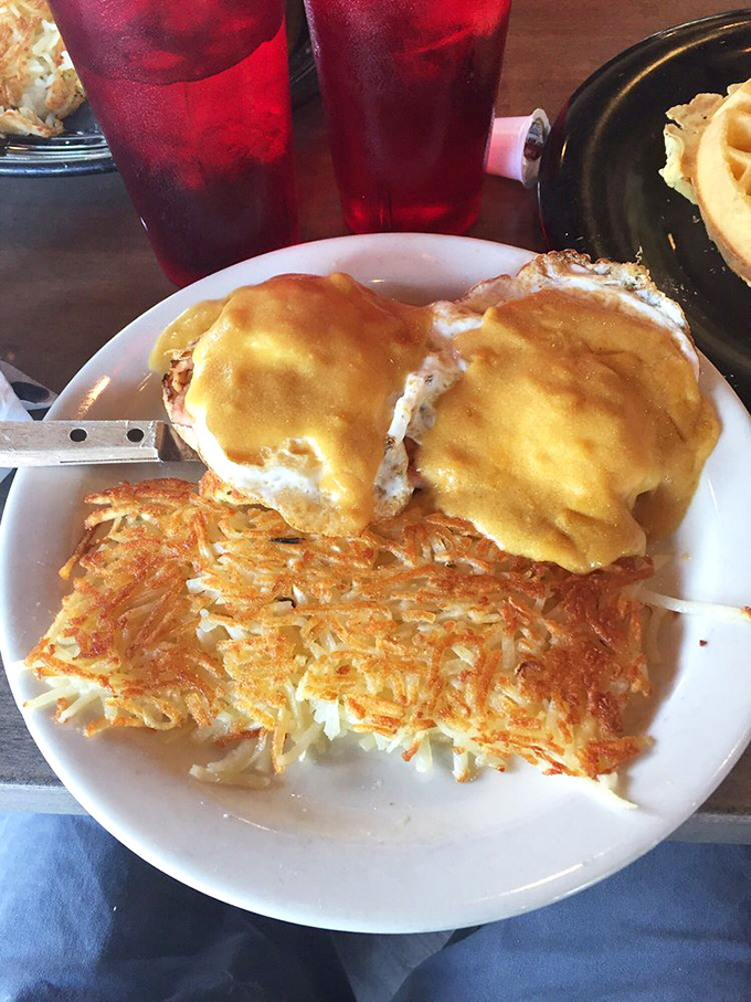 Eggs Benedict with hash browns that could make a cardiologist wince but are worth every delicious, cheese-covered bite.