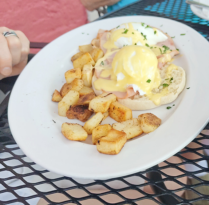 Eggs Benedict that makes you want to high-five the chef. Those home fries look like they've achieved the perfect crisp-to-fluffy ratio.