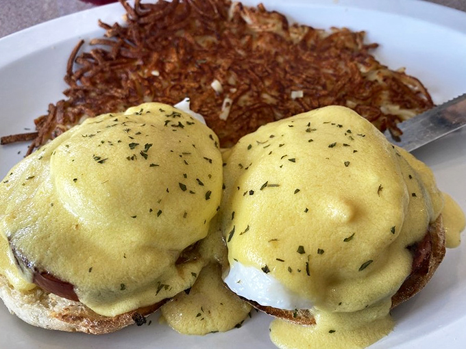 These Eggs Benedict deserve their own Instagram account. Golden hollandaise cascades over perfectly poached eggs while crispy hash browns stand ready for action.