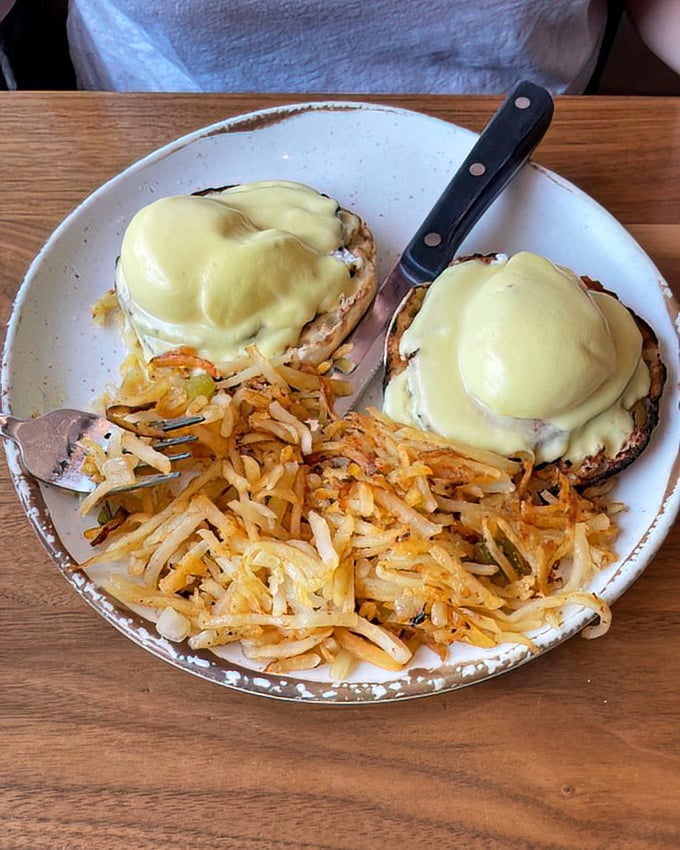 Eggs Benedict that would make a brunch enthusiast weep with joy, paired with hash browns that achieve that mythical balance of crispy exterior and tender heart.