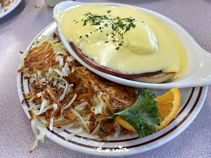 Hollandaise sauce cascades down this eggs Benedict like a yellow waterfall of happiness&mdash;the hash browns are just showing off at this point.