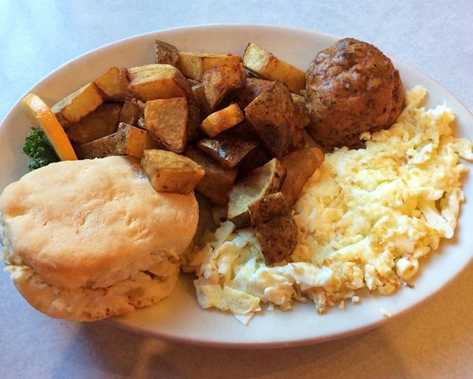 The breakfast trinity: perfectly scrambled eggs, home fries with just the right crisp, and a biscuit that would make your grandmother jealous.