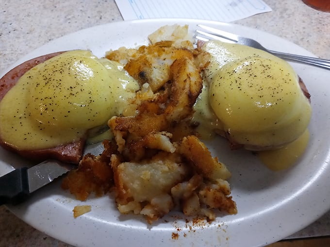 Eggs Benedict done right &ndash; perfectly poached eggs wearing hollandaise like a silk robe, perched atop Canadian bacon with crispy home fries standing guard.