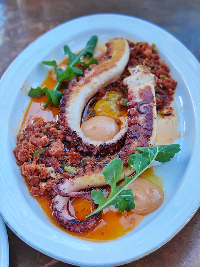 Octopus a la plancha: where tentacle meets technique. The perfect char gives way to tender meat that might convert even the skeptics.
