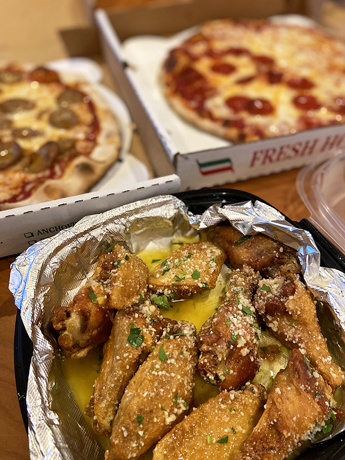 The holy trinity of pizza perfection: two personal pies and garlic knots dusted with parmesan that would make an Italian grandmother weep with joy.