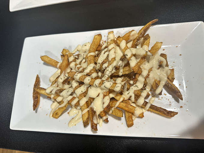 These aren't your cafeteria french fries. Hand-cut potatoes drizzled with creamy sauce create the kind of side dish that frequently steals the spotlight from the main event.