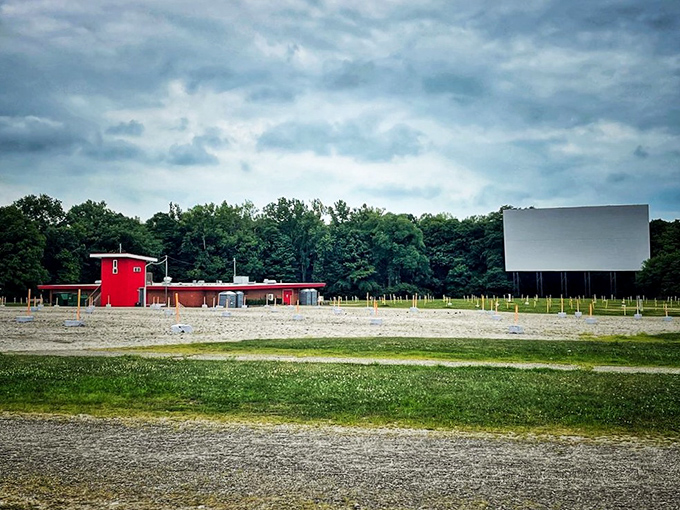 The bright red concession building anchors the grounds, promising treats while the massive screen awaits the evening's entertainment.