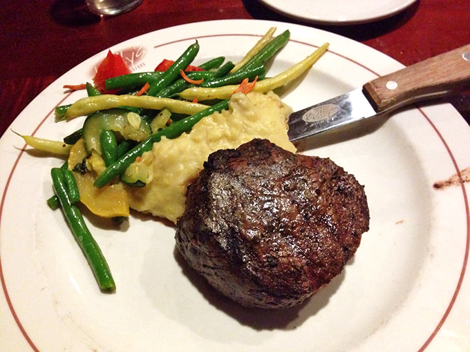 This filet mignon isn't just cooked&mdash;it's been treated with the respect a prime cut deserves, accompanied by creamy mashed potatoes and vibrant green beans.