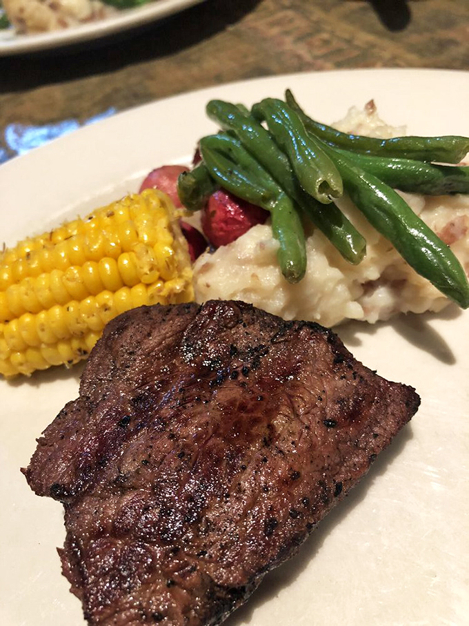 Steak perfection alongside corn and green beans &ndash; proof that classics endure for good reason. The holy trinity of American comfort.
