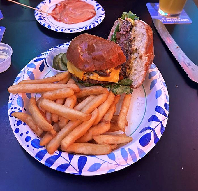 The burger arrives like a celebrity making an entrance&mdash;complete with golden fries standing at attention, ready to escort each bite to flavor town.