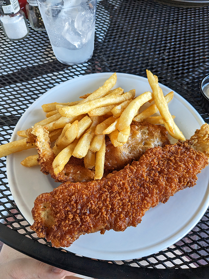 Golden-brown fish and chips that would make a British pub-goer nod in approval while reaching for the malt vinegar.