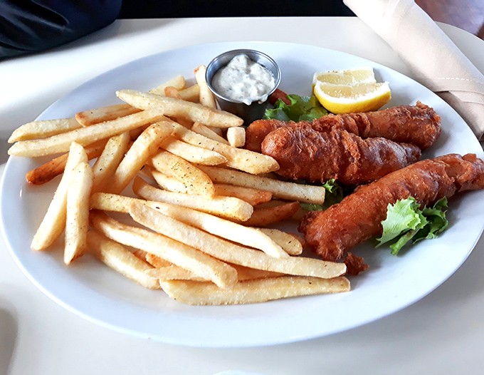 The fish and chips arrive golden and crispy, a testament that desert oases can indeed master seafood classics with coastal-worthy perfection.