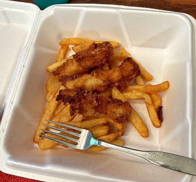 These fish and chips don't need a passport. Golden-battered perfection nestled among fries that somehow maintain their structural integrity despite the journey.