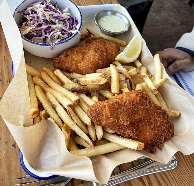 Fish and chips that achieve the golden ratio of crispy exterior to flaky interior. The coleslaw adds that perfect tangy counterpoint.