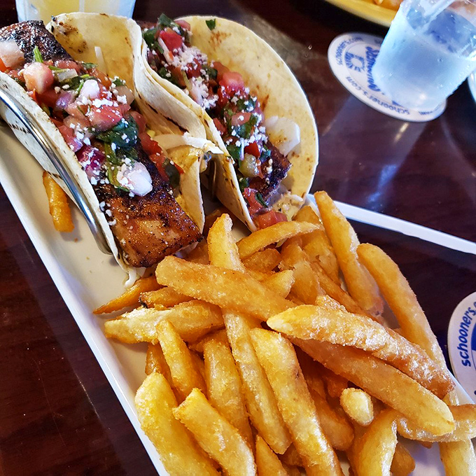 These fish tacos aren't just a meal; they're edible postcards from paradise, complete with golden fries that deserve their own fan club.