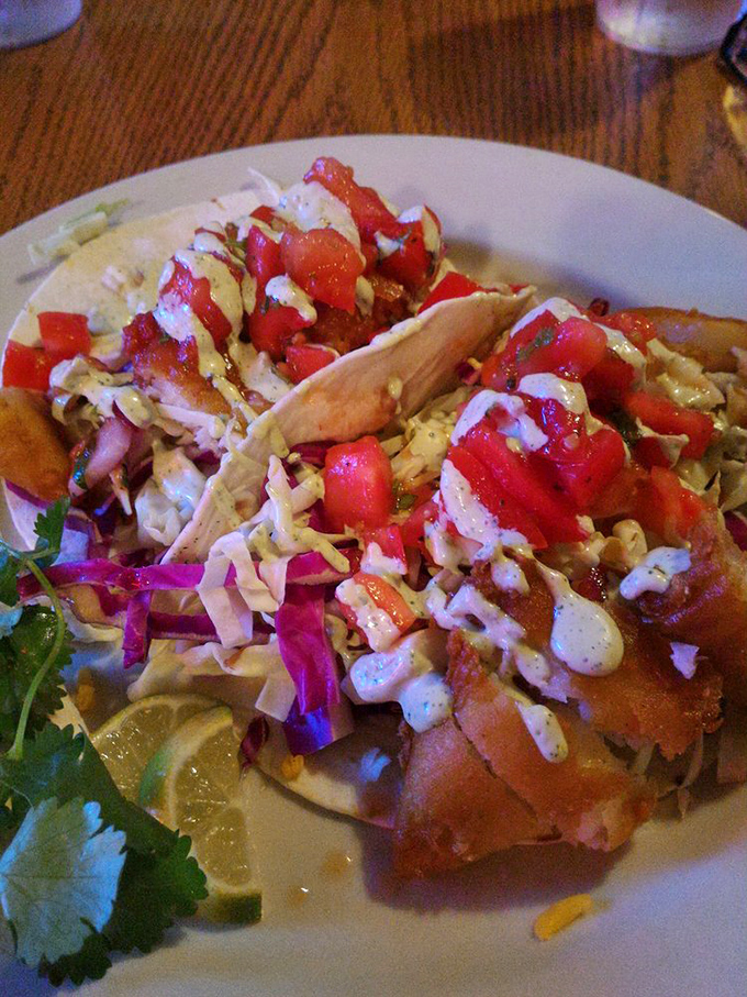 Fish tacos that bring a splash of coastal flair to this BBQ joint, topped with fresh veggies and a drizzle that ties everything together.