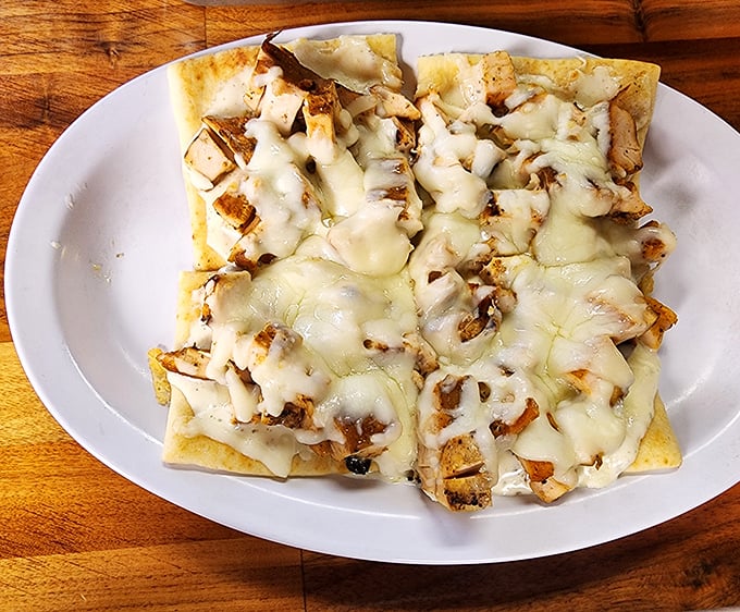 This flatbread isn't trying to be fancy &ndash; it's just honest-to-goodness BBQ chicken melted under a blanket of cheese that stretches for days.