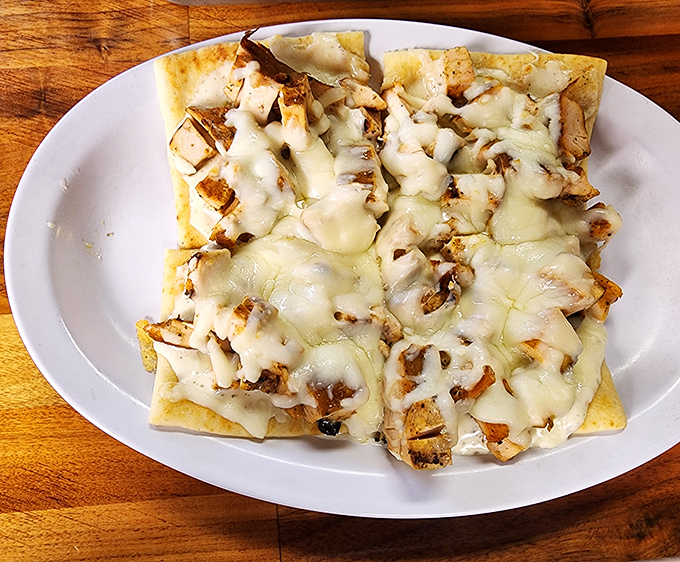 This flatbread isn't trying to be fancy &ndash; it's just honest-to-goodness BBQ chicken melted under a blanket of cheese that stretches for days.